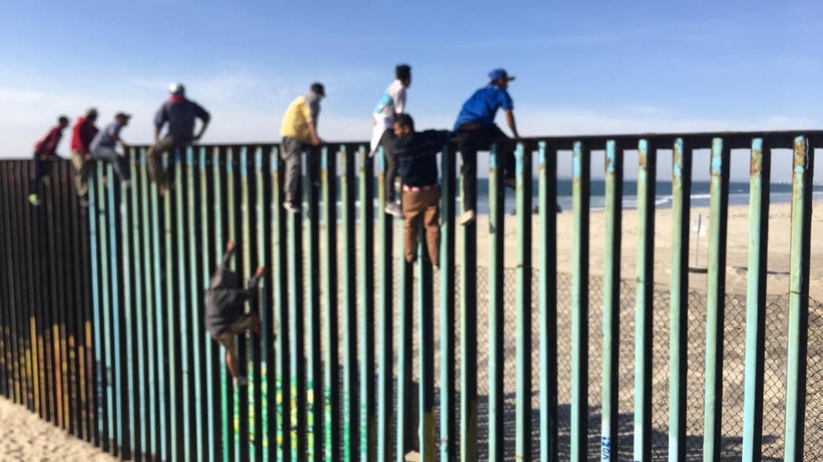 Stunning Images Show Migrant Caravan Members Atop Border Fence – NBC 7 ...