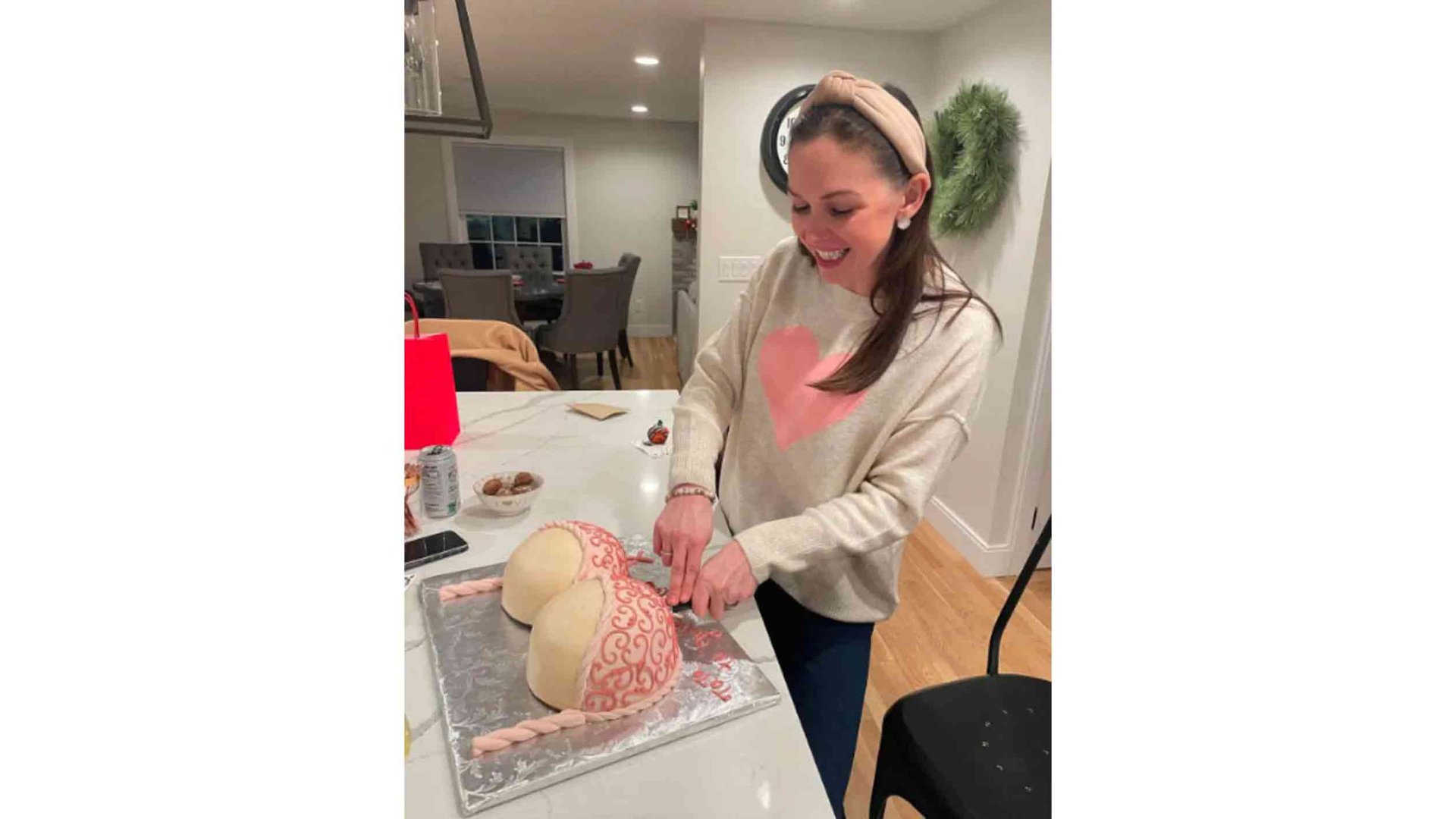 Julie Devaney Hogan cutting a boob cake for her “boob voyage” party ...