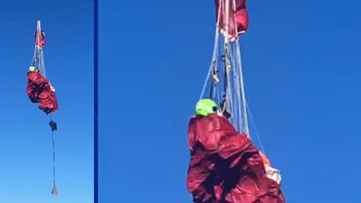 Firefighters rescue skydiver hanging over roadway from parachute ...